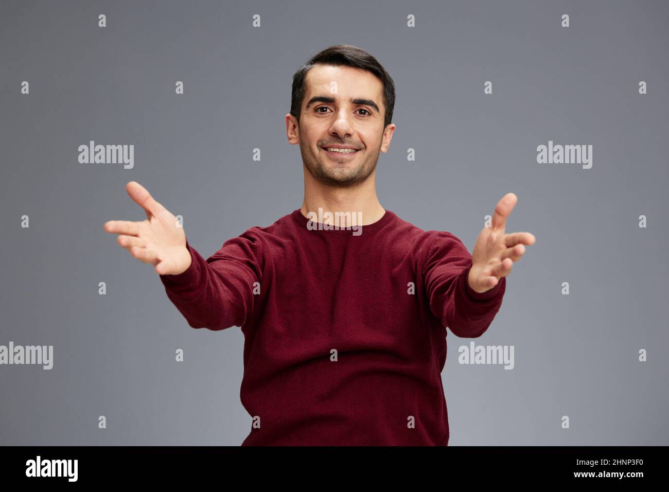 man smile welcome hand gesture posing gesture with hands red sweater ...
