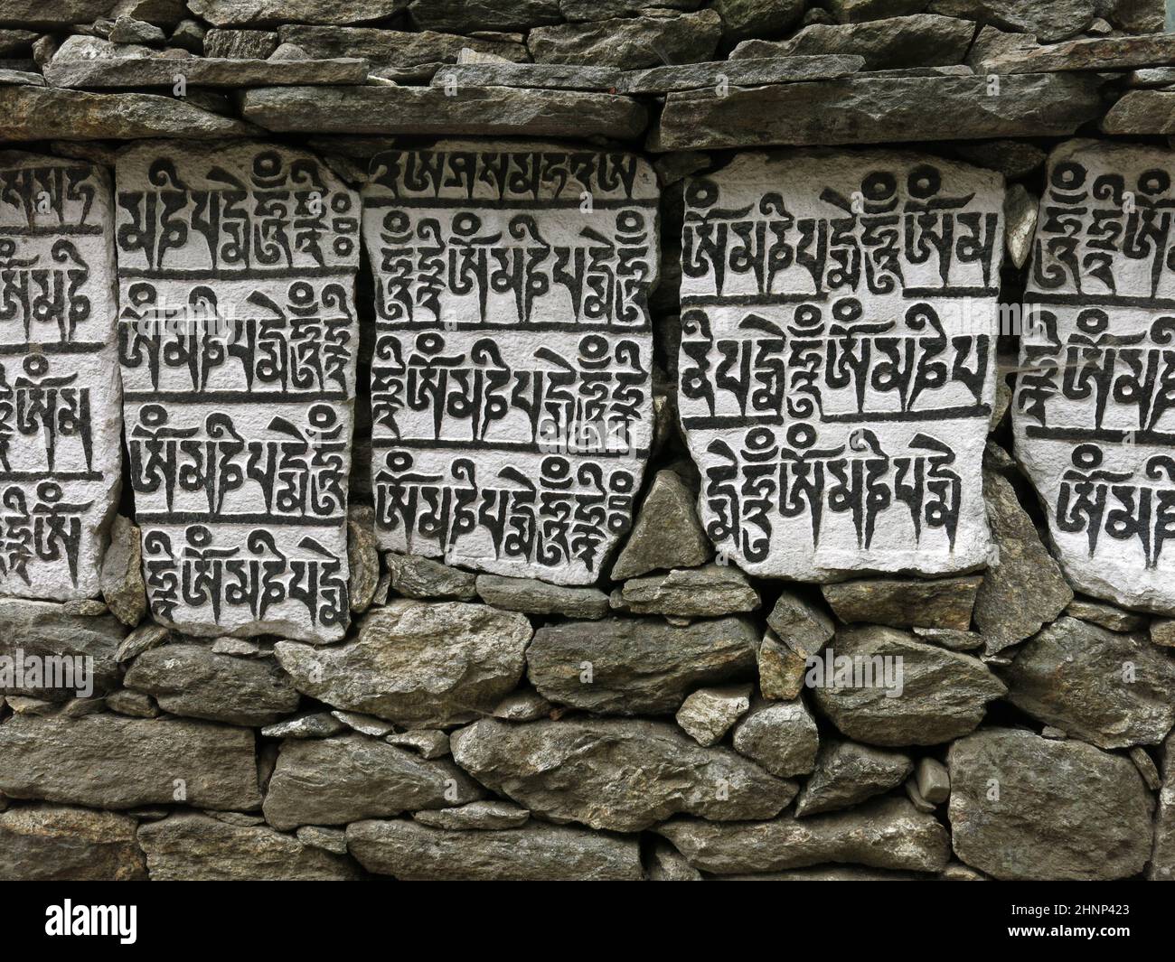 Mani wall, buddhist mantra carved in stones Stock Photo - Alamy