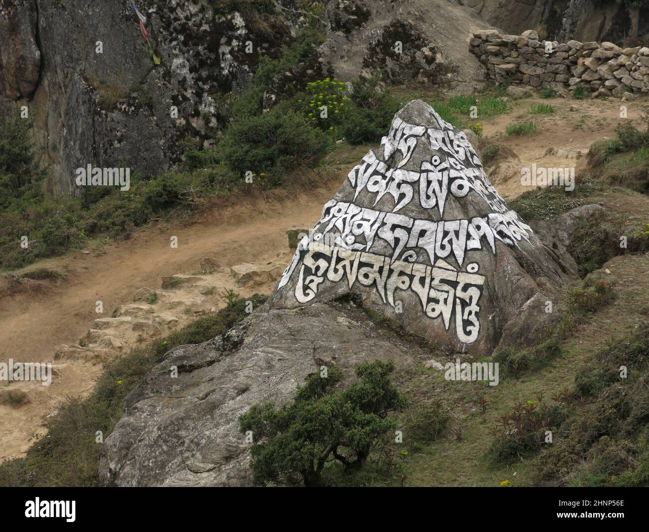 Mani stone, engraved buddhist mantra Stock Photo - Alamy