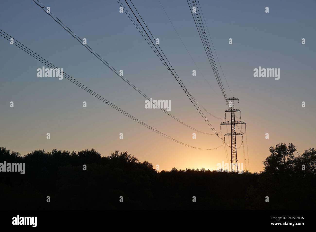 Power grid ultra high voltage electric line in sunrise light Stock ...