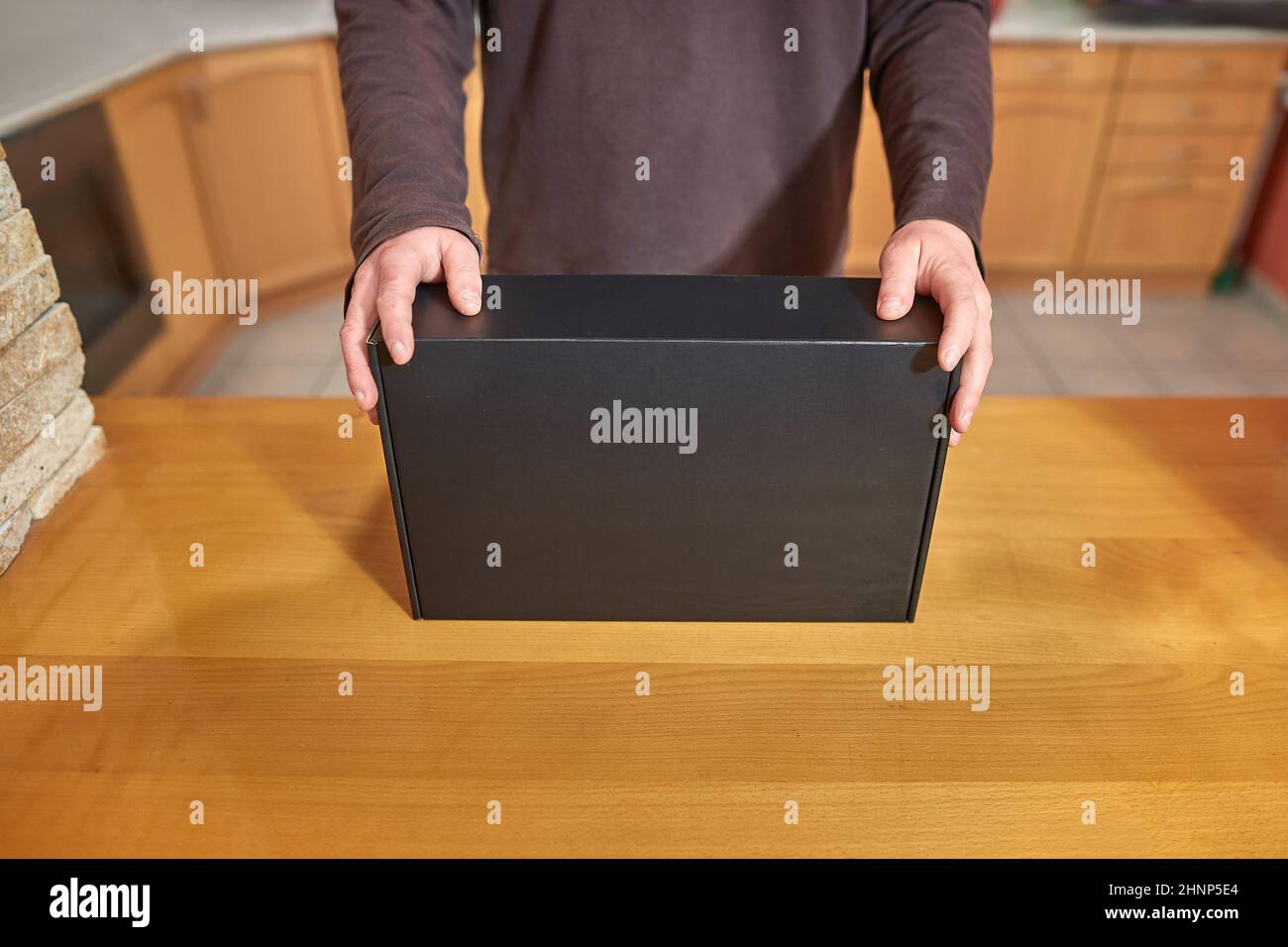 Shop assistant showing a blank black box of computer hardware equipment ...