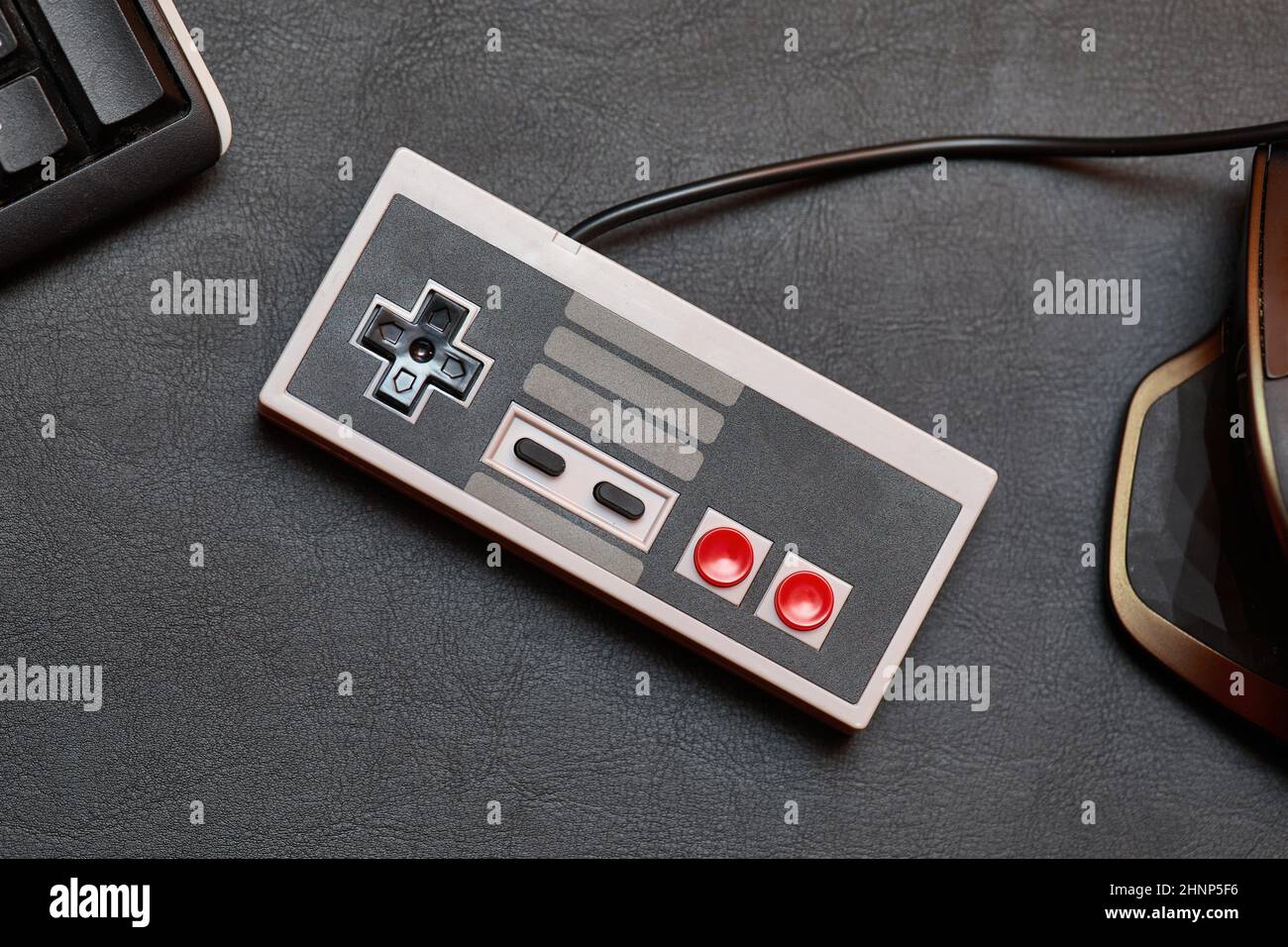 Old video game controller on a desk Stock Photo - Alamy