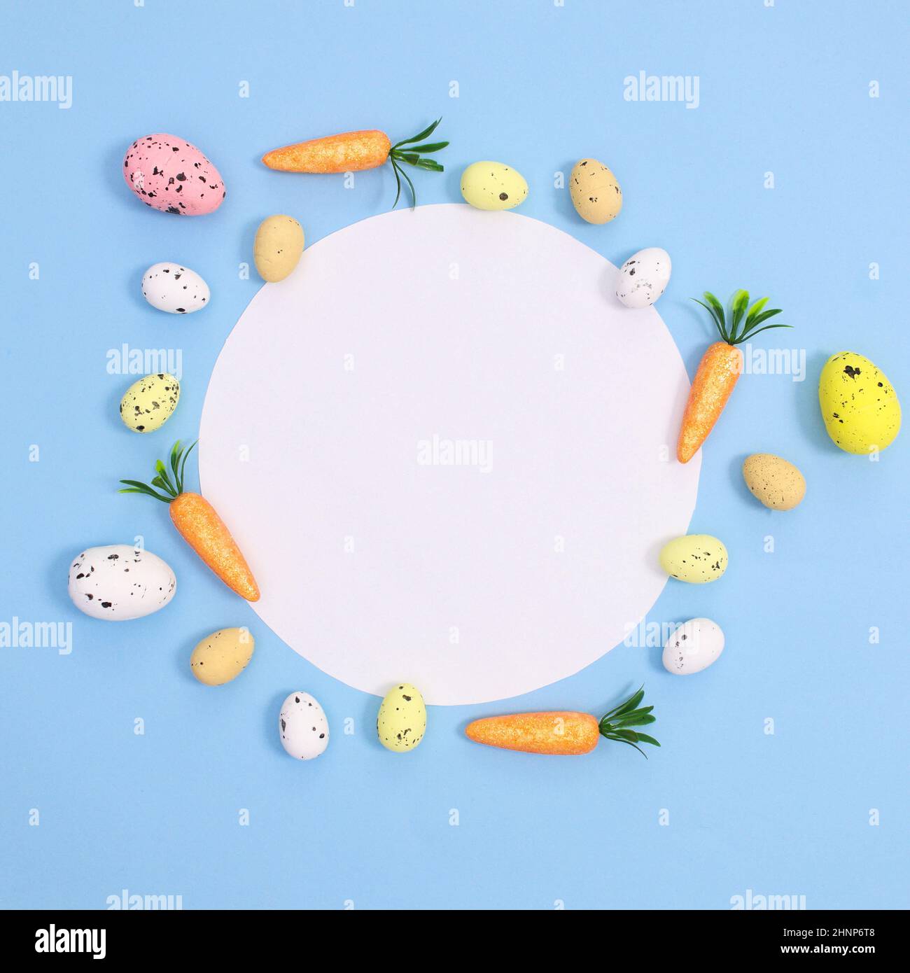 Easter paper card copy space with eggs and carrots on bright pastel ...