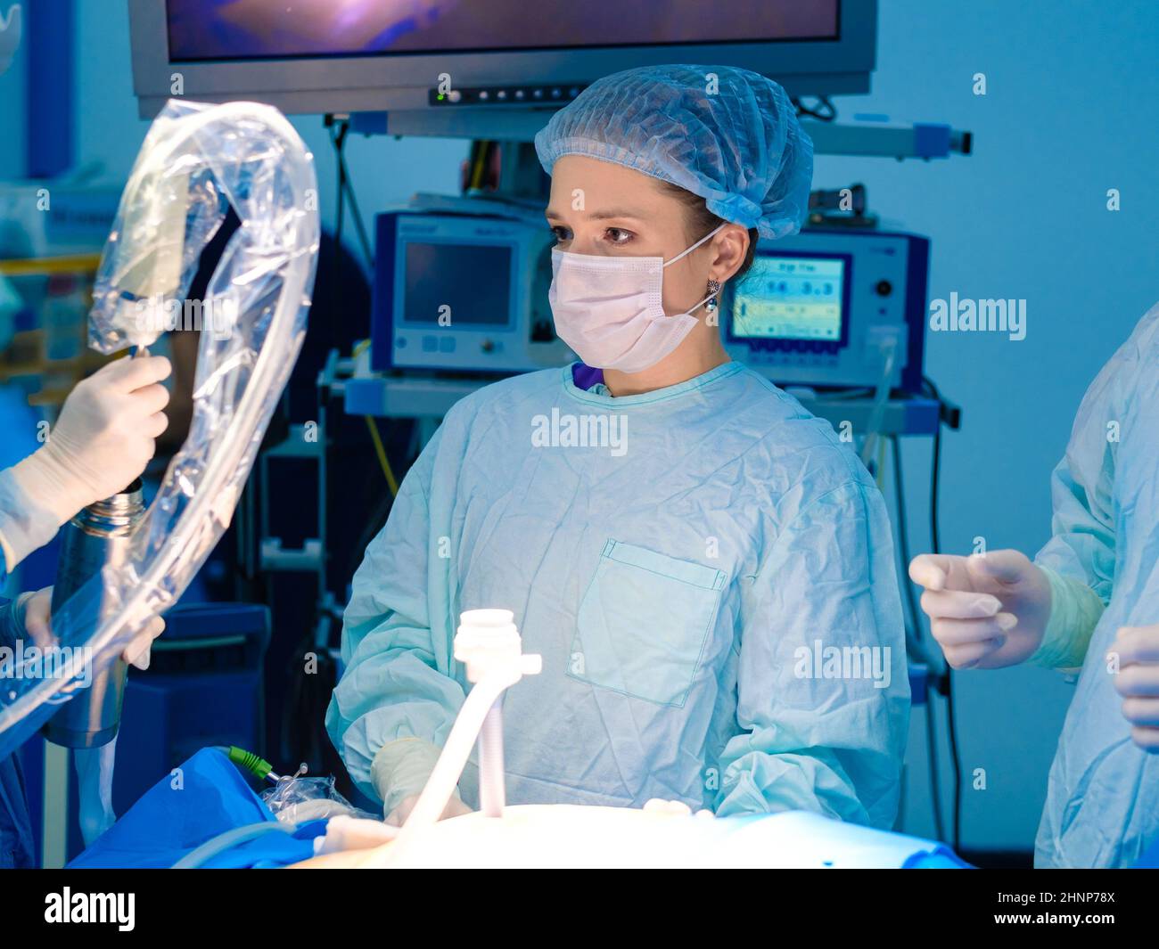 Professional female doctor in a mask and uniform in the operating room ...