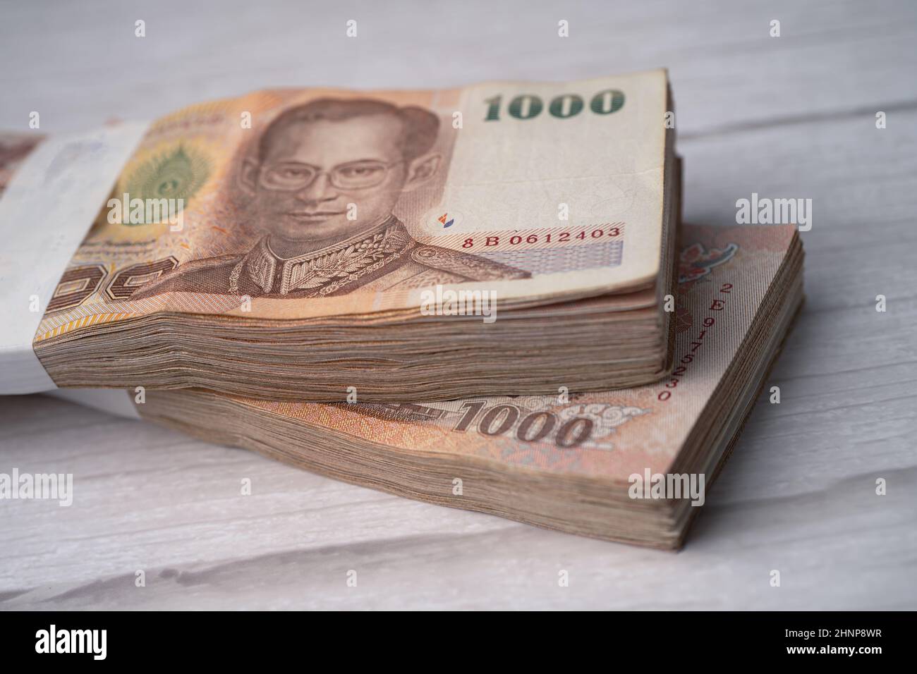 Stack of Thai baht banknotes on wooden background, business saving ...