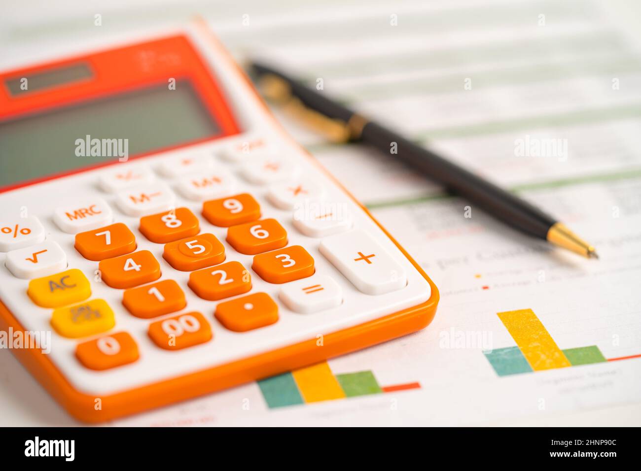Calculator with pen on chart graph paper, finance, account, statistic ...