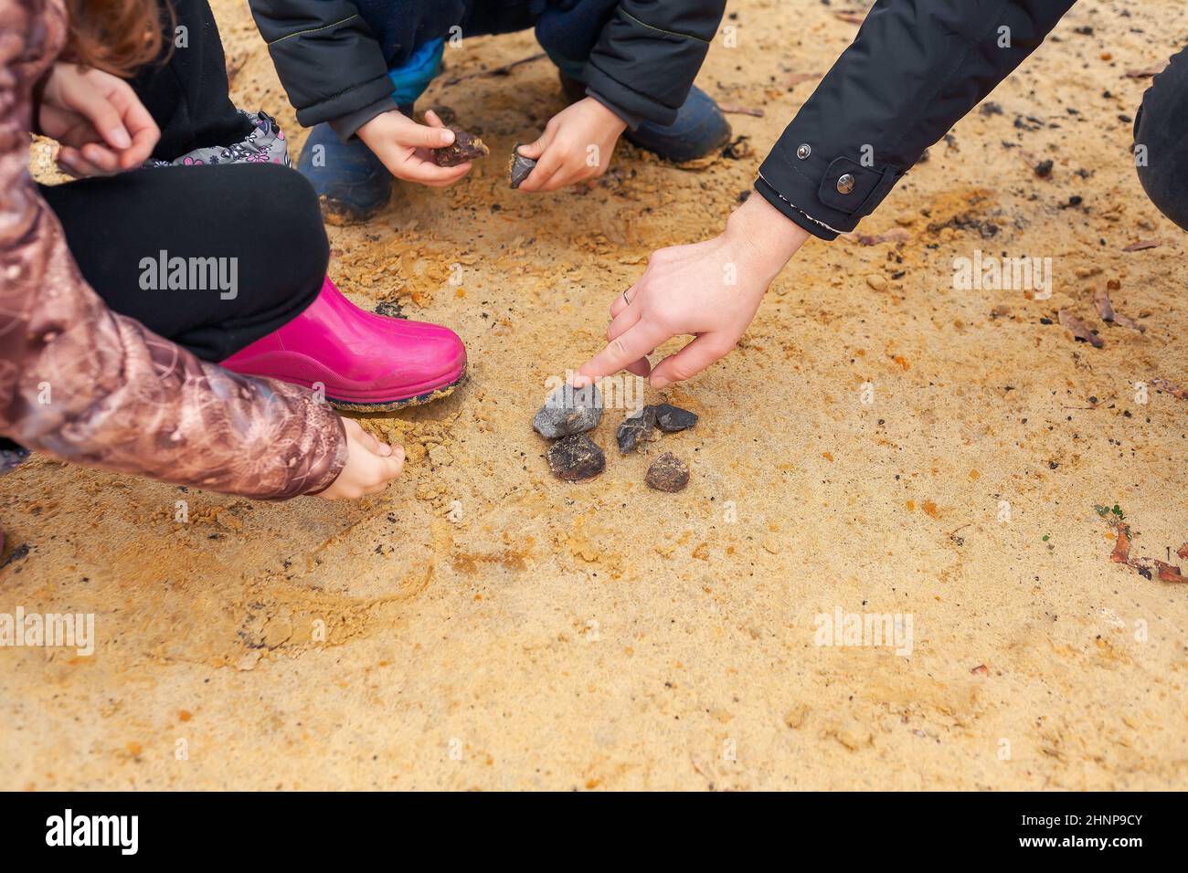 Children explore rocks and minerals in the sand Stock Photo - Alamy
