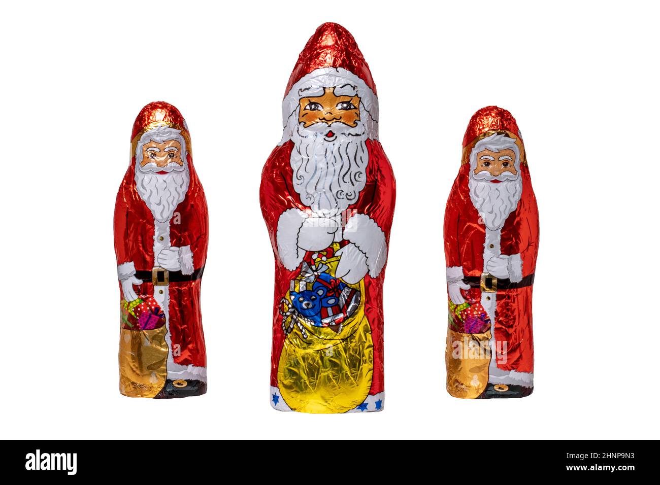 Chocolate Santa isolated. Close-up of three cheerful wrapped chocolate ...
