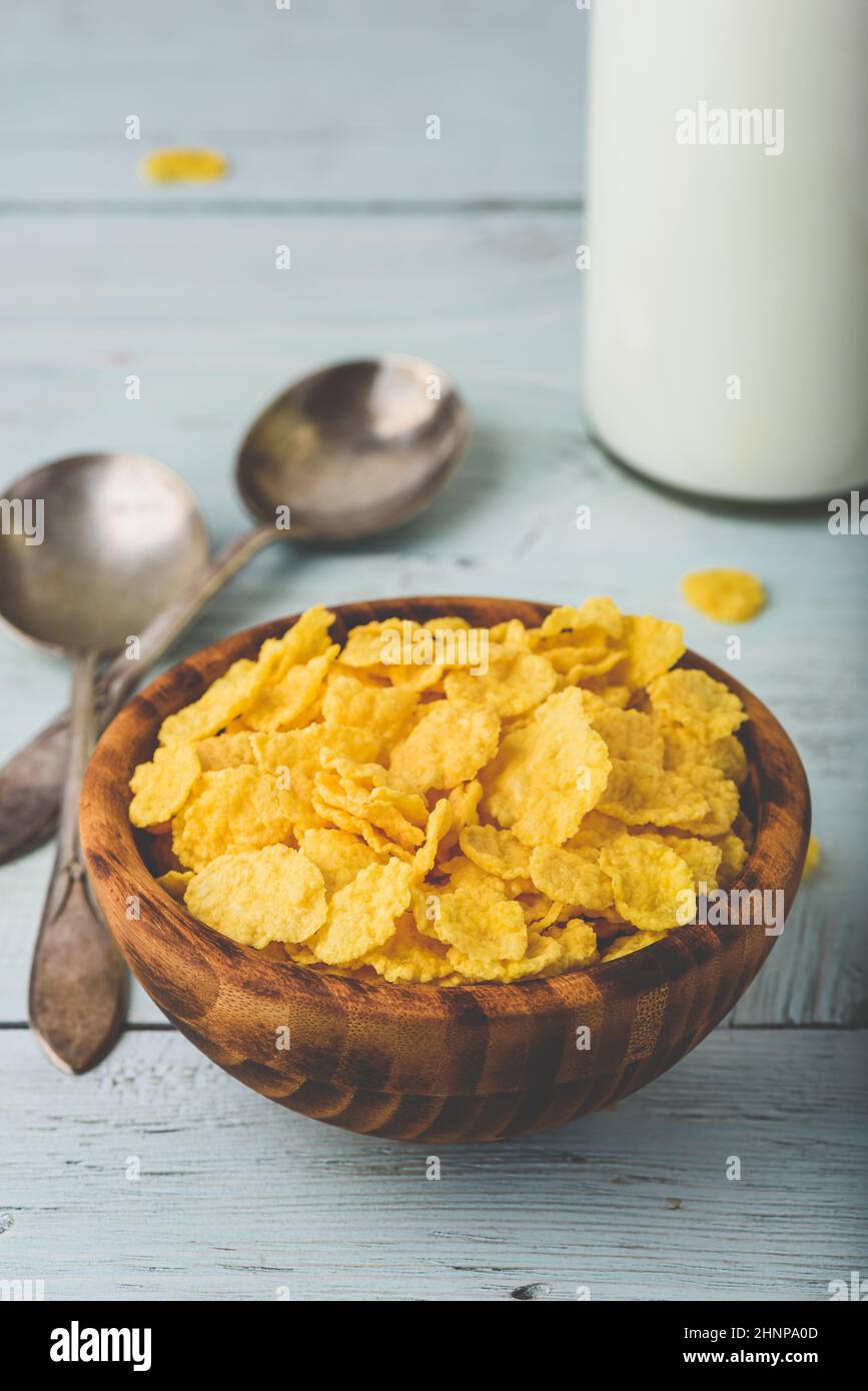 Rustic bowl of corn flakes with spoons and bottle of milk Stock Photo ...