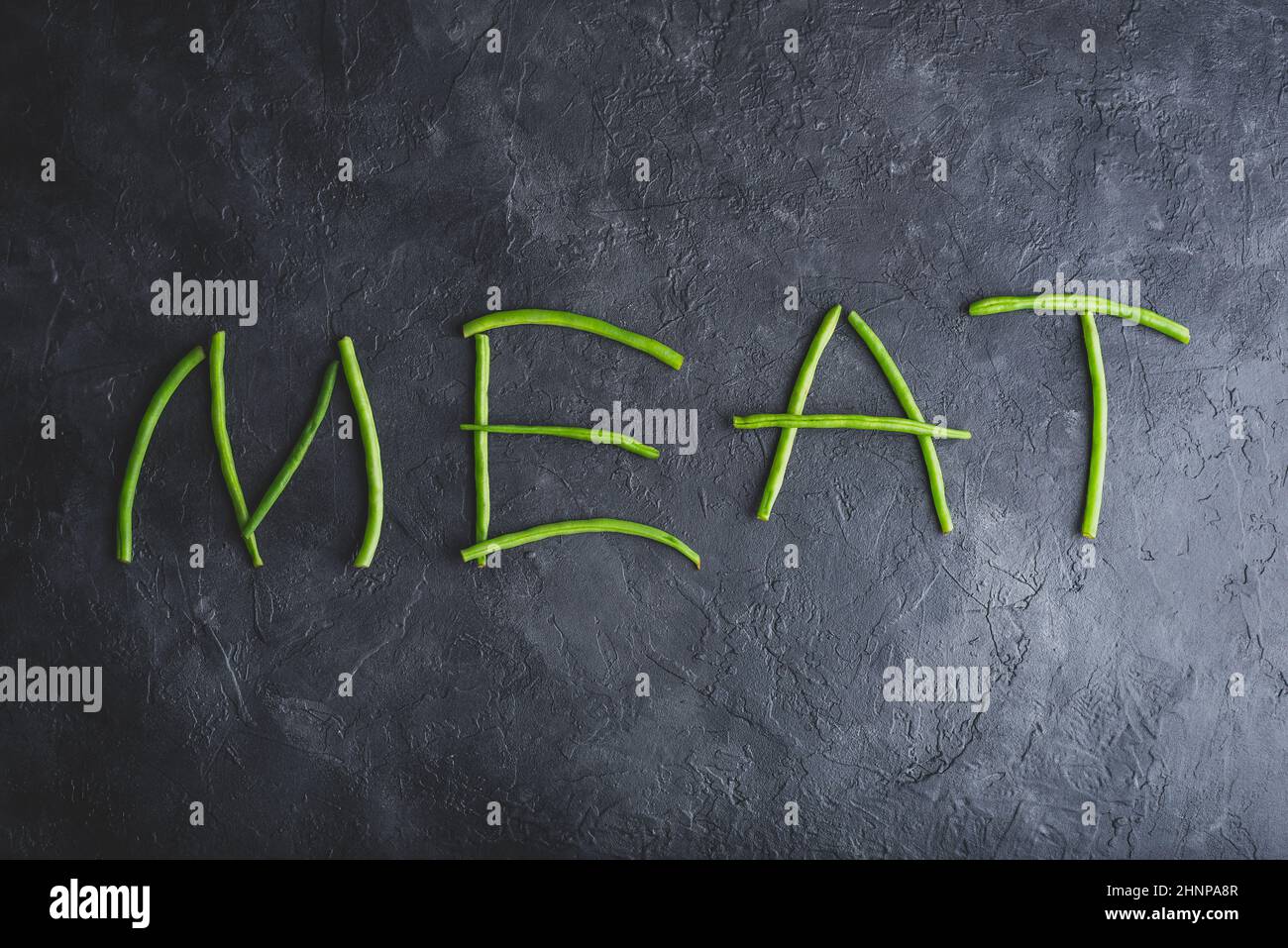 Word Meat Spelled Out In Fresh Pods of Green Beans on Dark Concrete ...