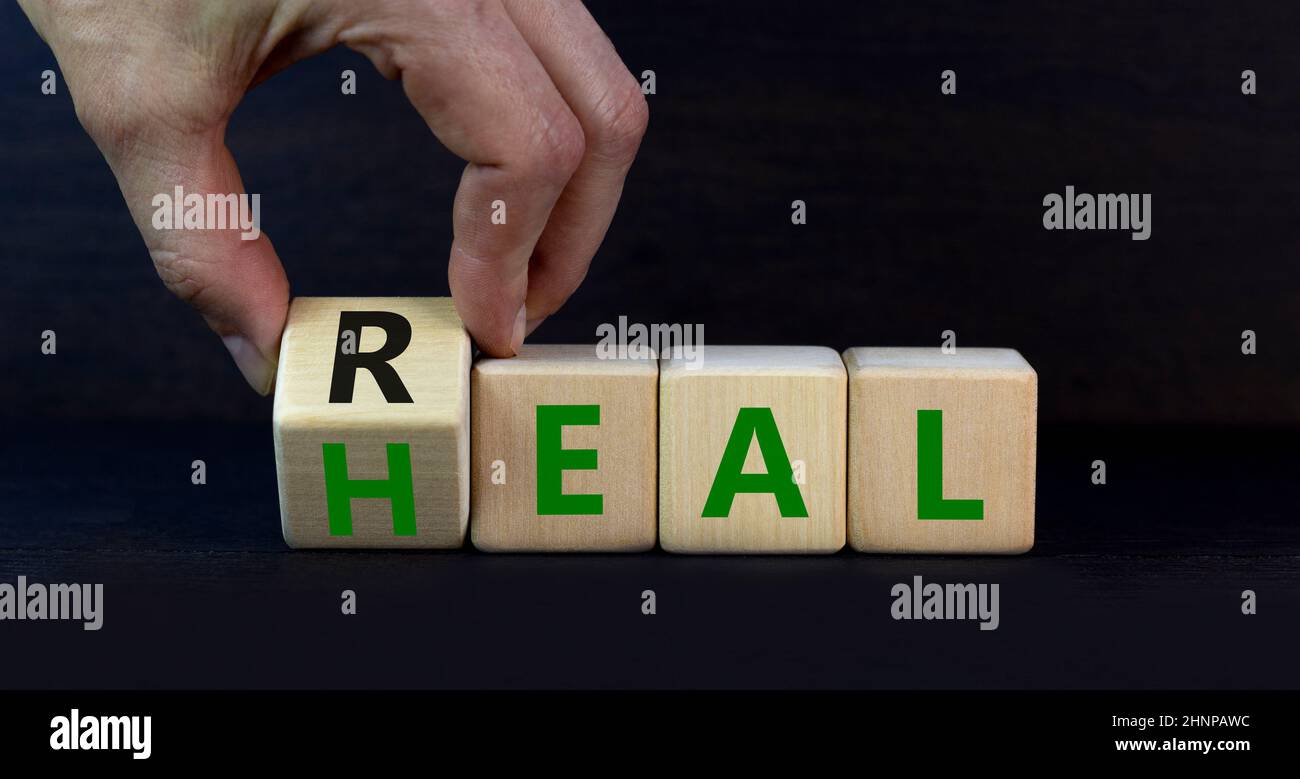 Real heal symbol. Doctor turns a wooden cube with concept words Real ...