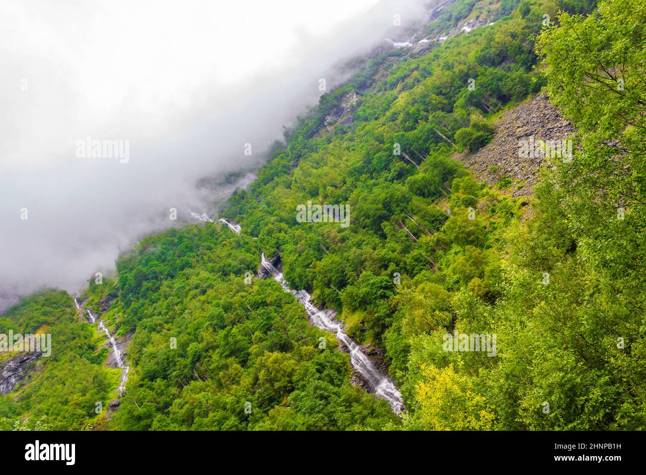 Fog mist clouds rain and waterfall on mountain in norwegian landscape ...