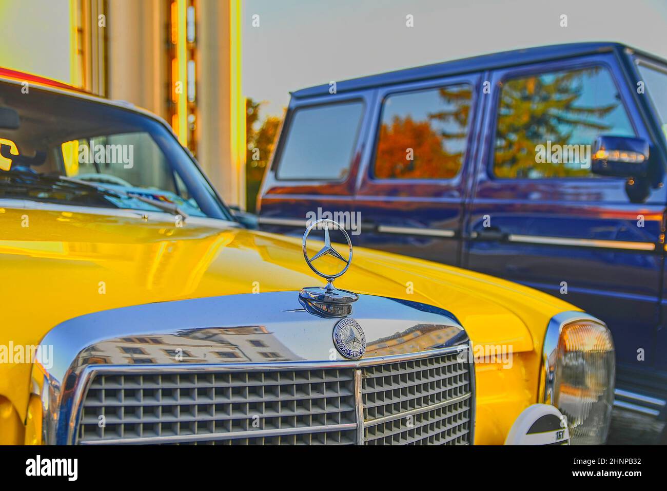 Mercedes Benz logo on a yellow vintage car. Mercedes-Benz is a German ...