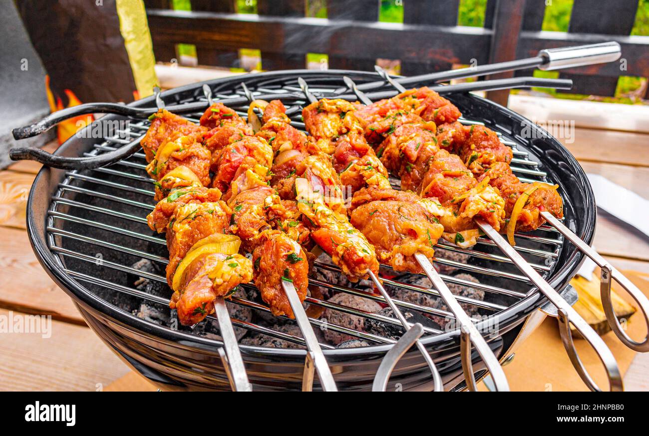 Russian shashlik with skewers on a round grill in Norway Stock Photo ...