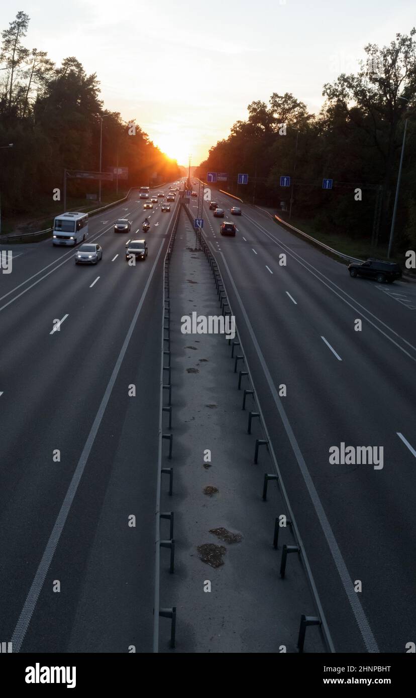 Moving cars on the motorway at sunset time. Highway traffic at sunset ...