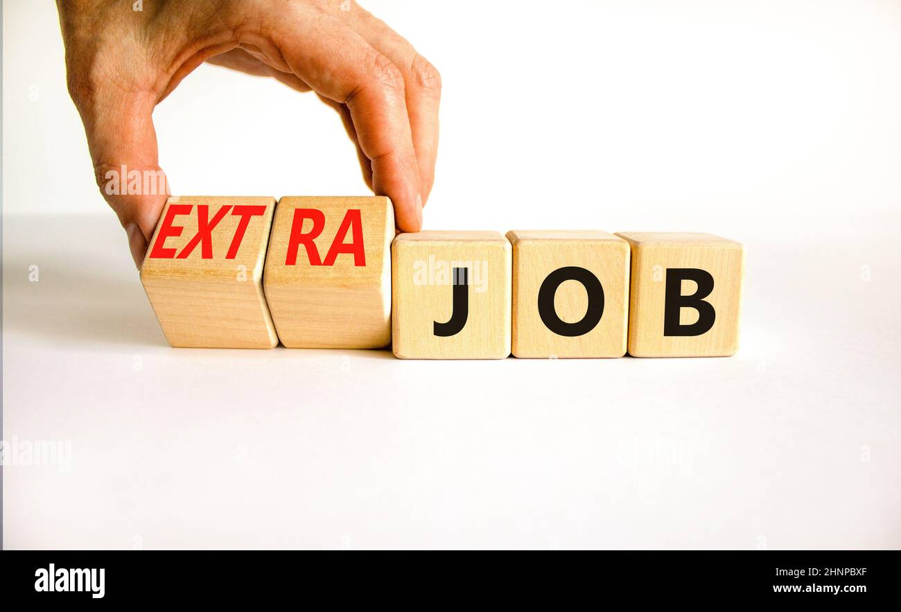 Extra job symbol. Businessman turns wooden cubes and changes concept ...