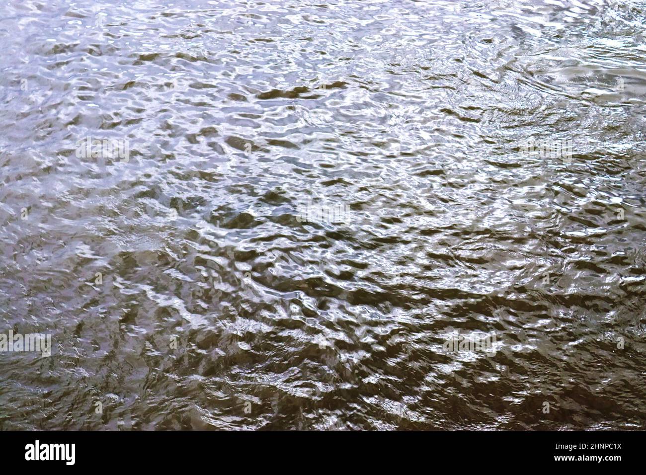 Detailed close up view on water surfaces with waves and ripples and the ...