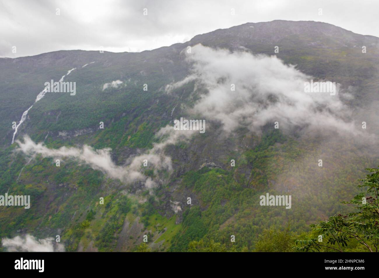 Fog mist clouds rain and waterfall on mountain in norwegian landscape ...