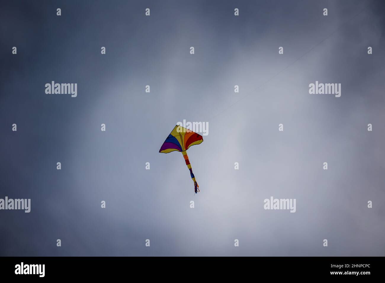 A colorful stunt kite, kite with colorful tails in the sky Stock Photo ...