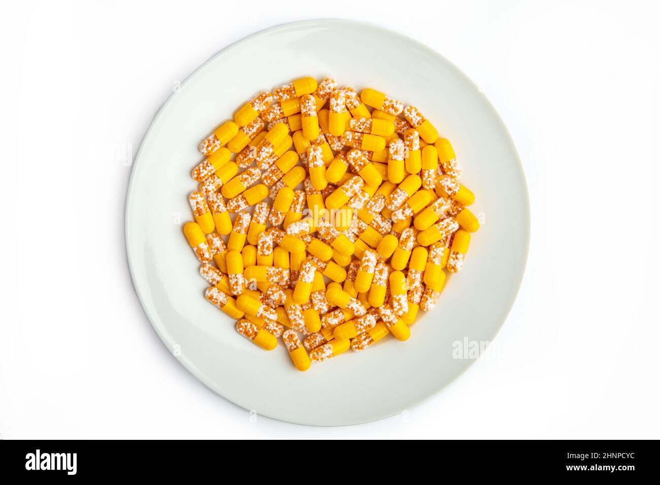 Yellow capsules on a white plate isolated on white background Stock ...