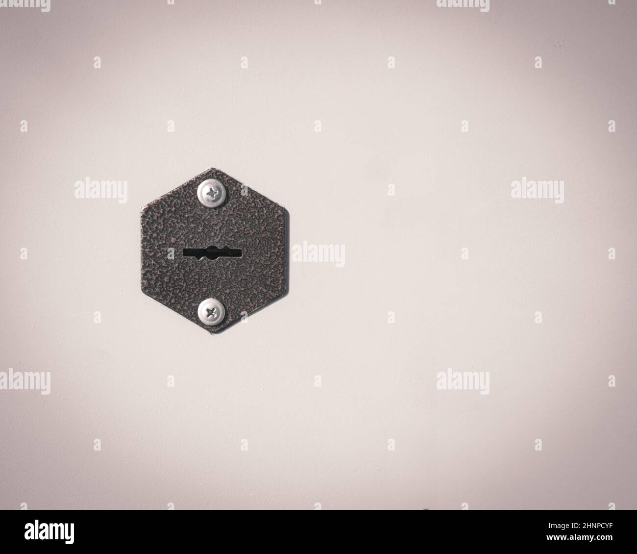 A metal keyhole of the door close-up colored Stock Photo - Alamy