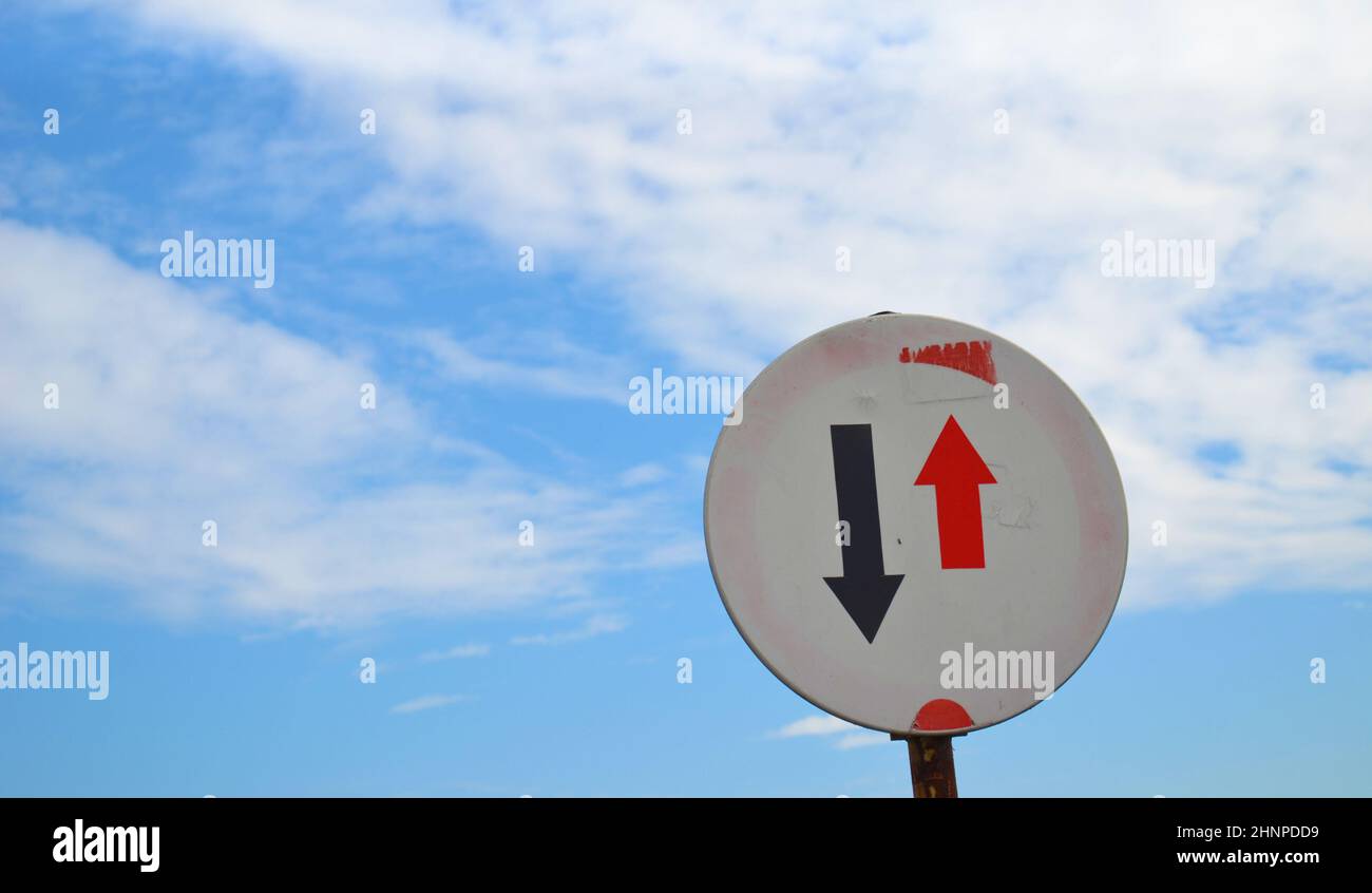 Road sign that shows right of way on cloudy day Stock Photo - Alamy