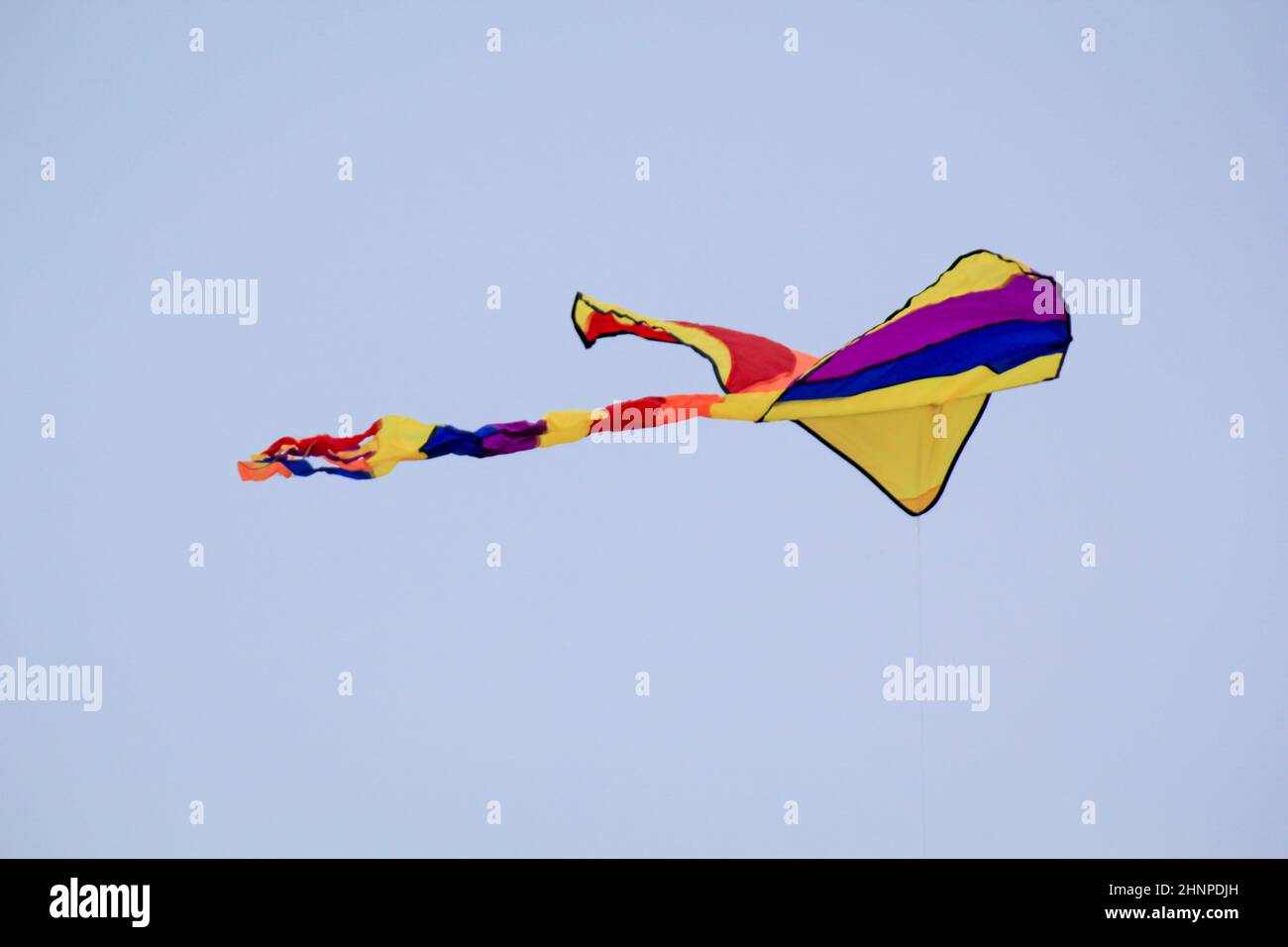 A colorful stunt kite, kite with colorful tails in the sky Stock Photo ...