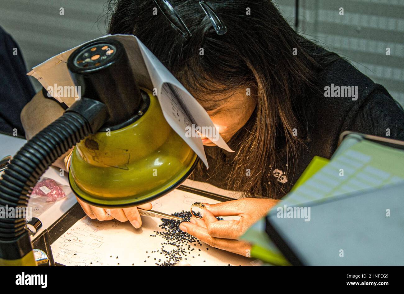 female goldsmith prepares a ring with gemstones Stock Photo - Alamy