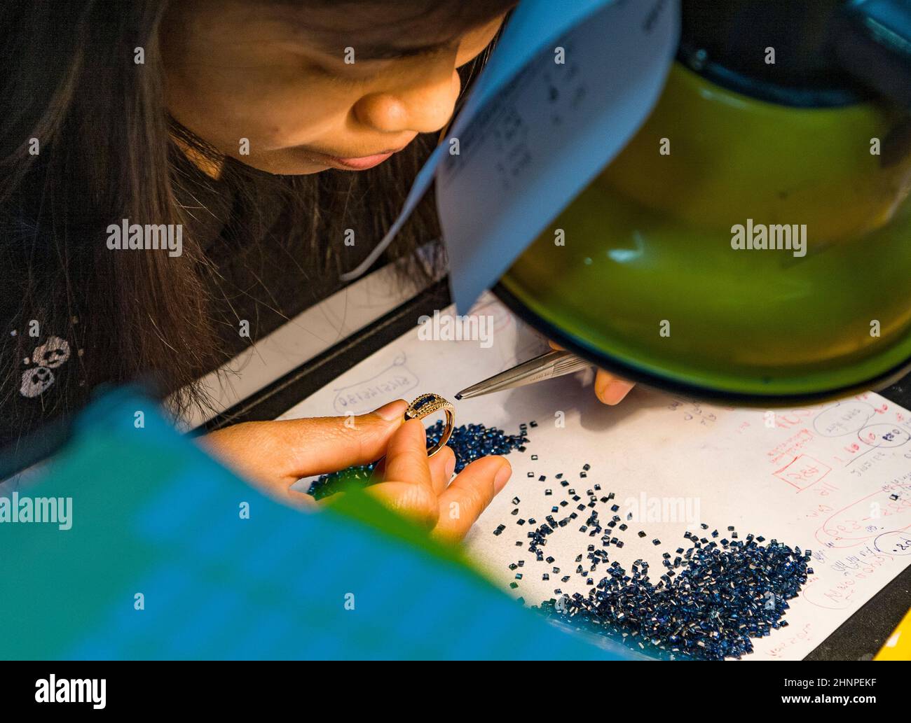 female goldsmith prepares a ring with gemstones Stock Photo - Alamy