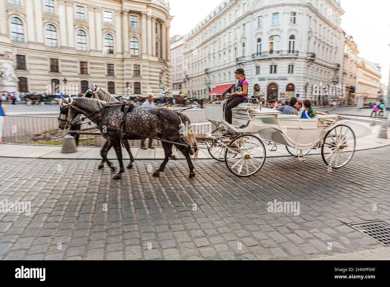 people have a ride in the horsedrawn carriage called fiaker Stock Photo ...
