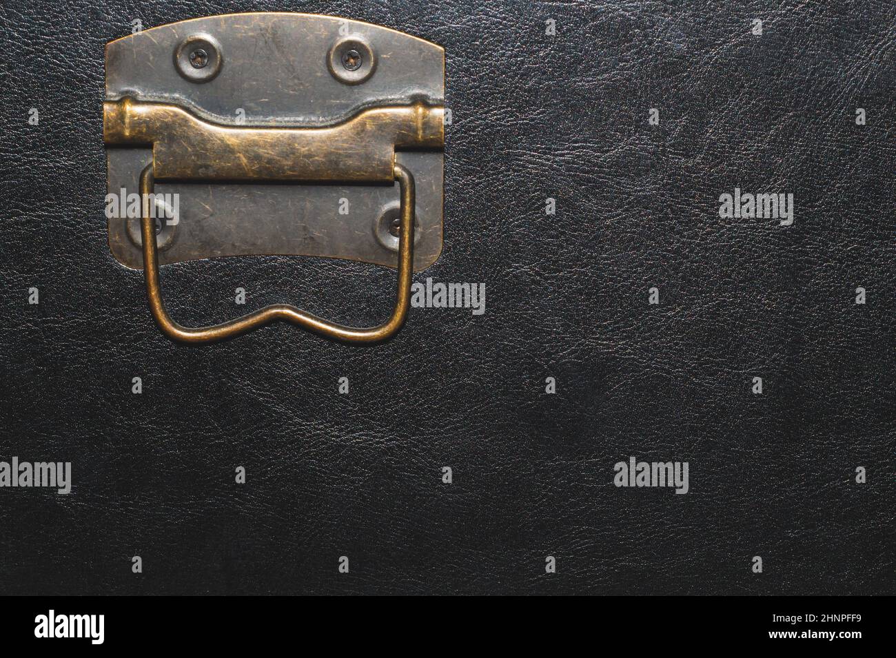 Metal handle with black leather background Stock Photo - Alamy