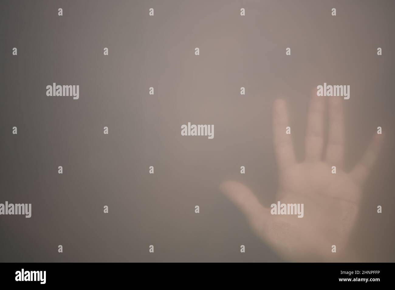 Hands behind the frosted glass. hands silhouette in the mist ...