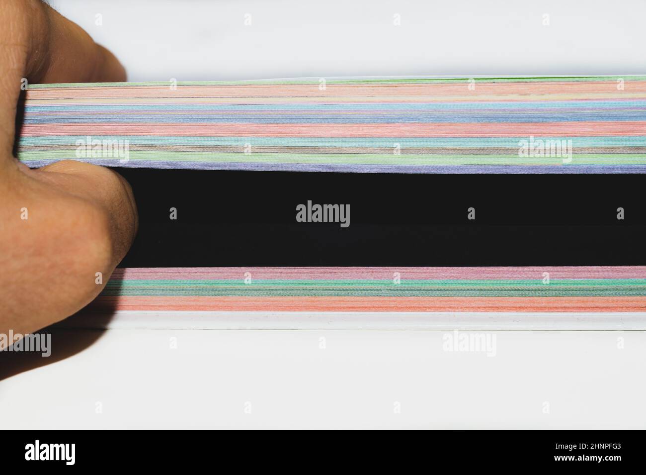 Book is open on a black page. colorful book edge close up. copy space ...