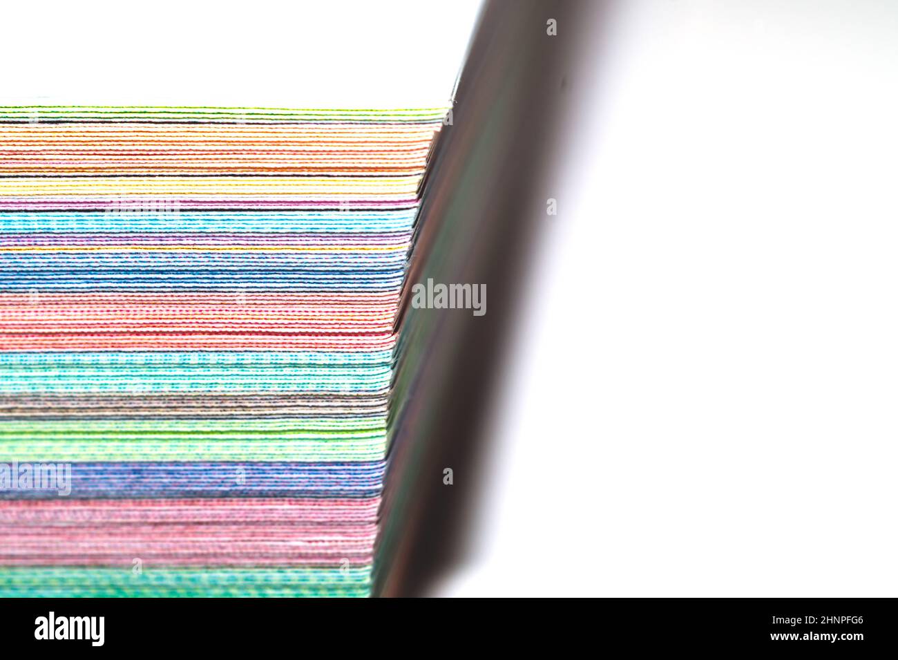 Edge of a book with colorful pages macro. copy space Stock Photo - Alamy