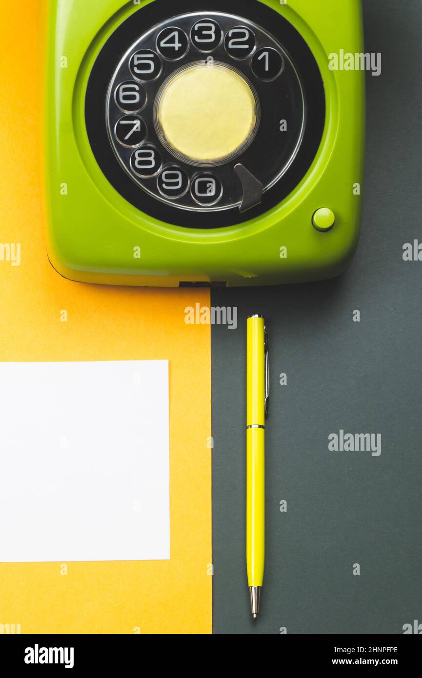 Classic phone. pen with a note. office background. vintage green ...