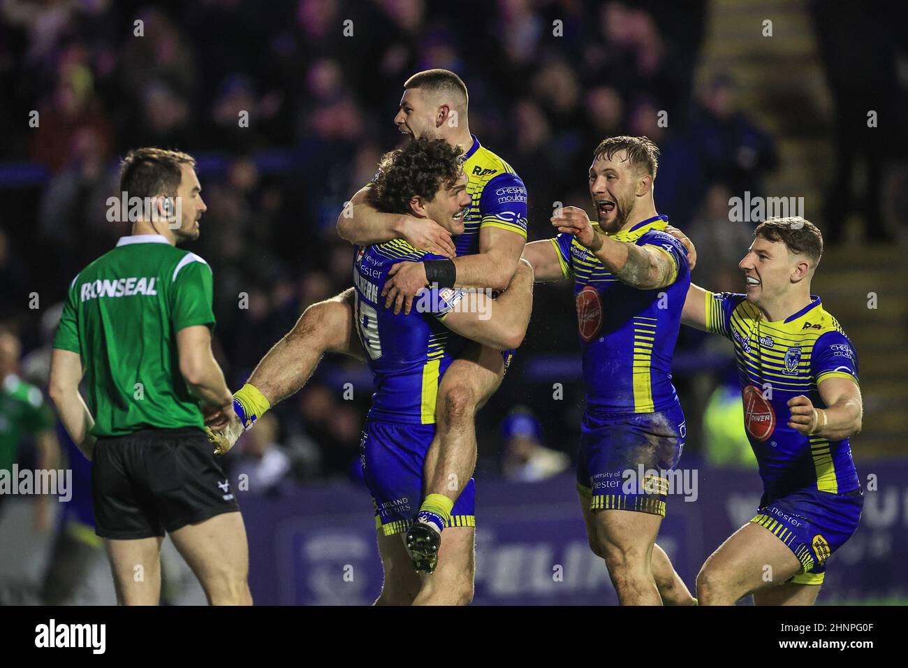 Rob Mulhern #19 of Warrington Wolves celebrates his try with team mates ...