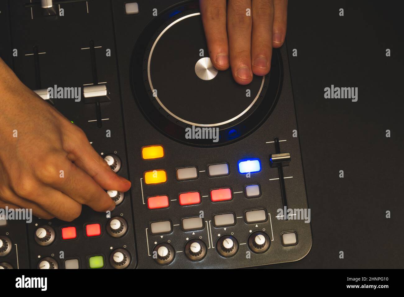 DJ plays music. sound mixer controller with knobs and sliders close up ...