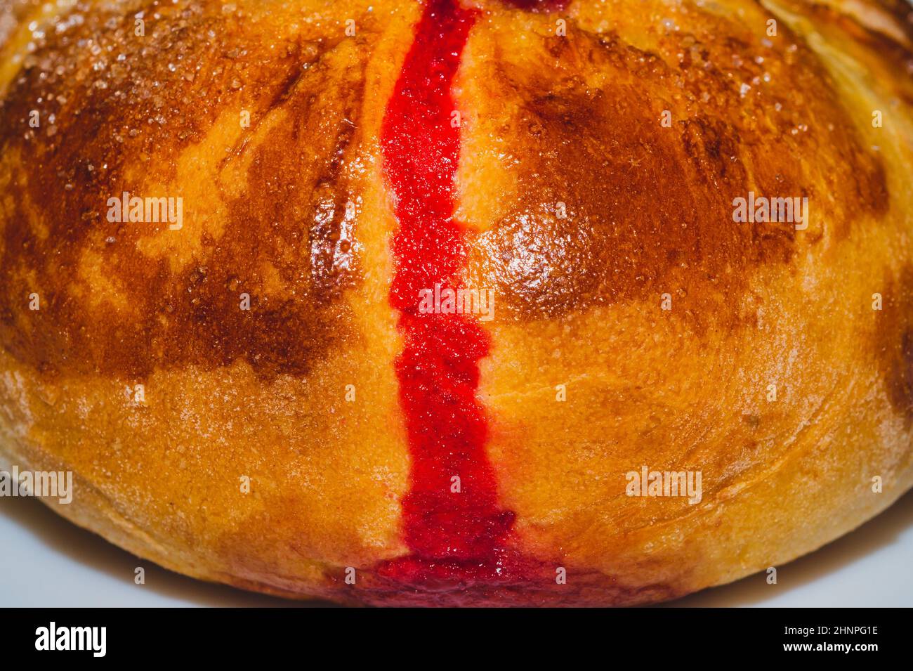 Bun with red sweet jam inside. sweet baking close up Stock Photo - Alamy