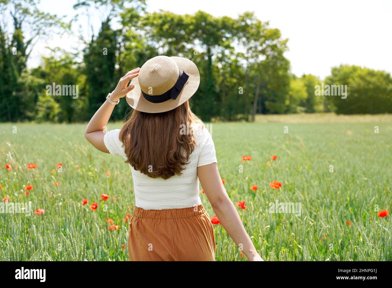 Back view of a young woman who regenerates herself walking in the ...