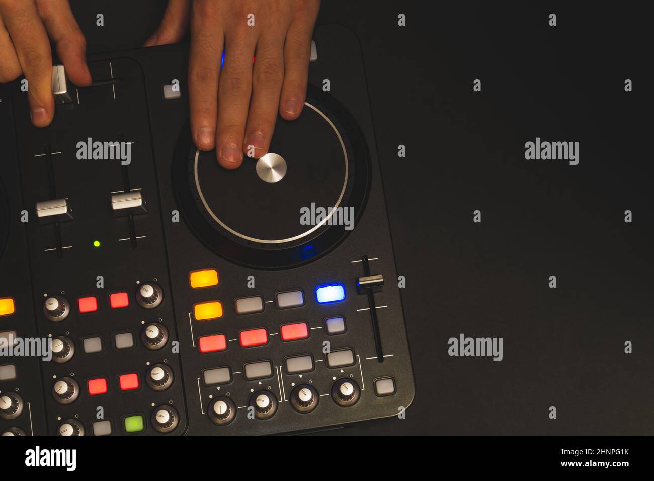 DJ plays music. sound mixer controller with knobs and sliders close up ...