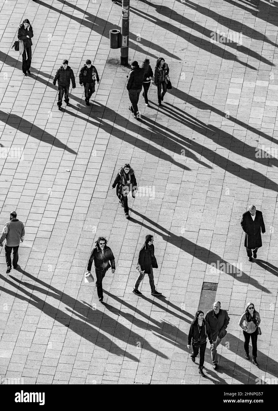 people walking at the street with long shadows Stock Photo - Alamy