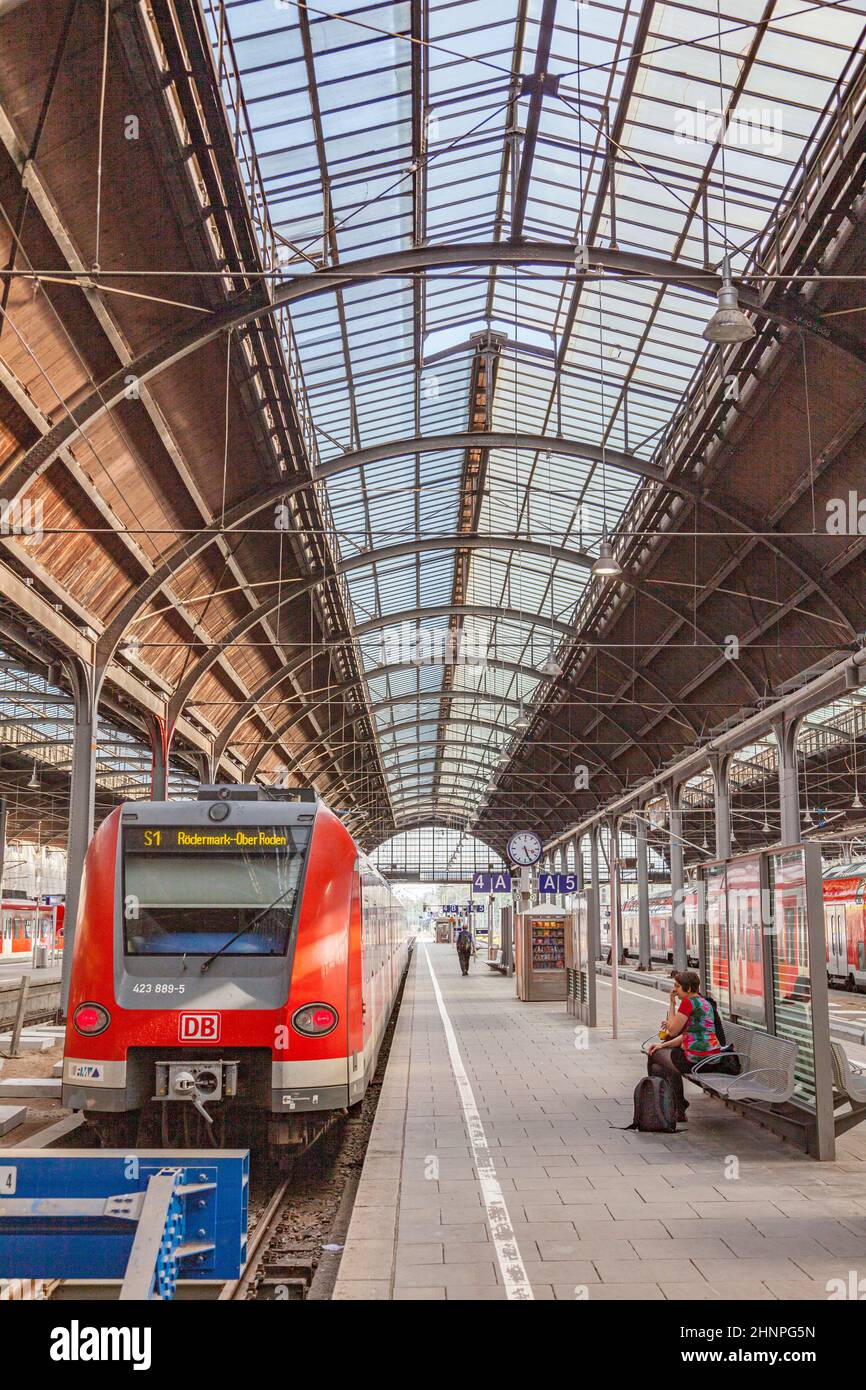 people hurry to the train at historic classicistic train station in ...