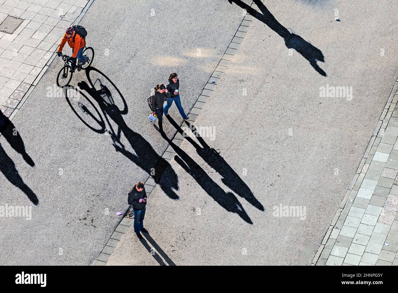 people walking at the street with long shadows Stock Photo - Alamy
