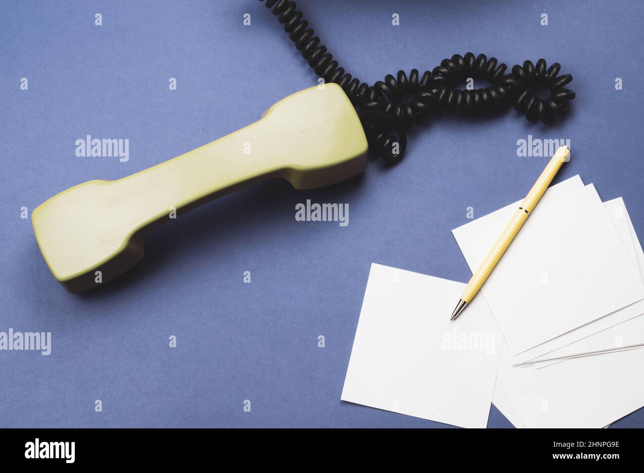Vintage telephone handset. pen and a note. office background. phone ...