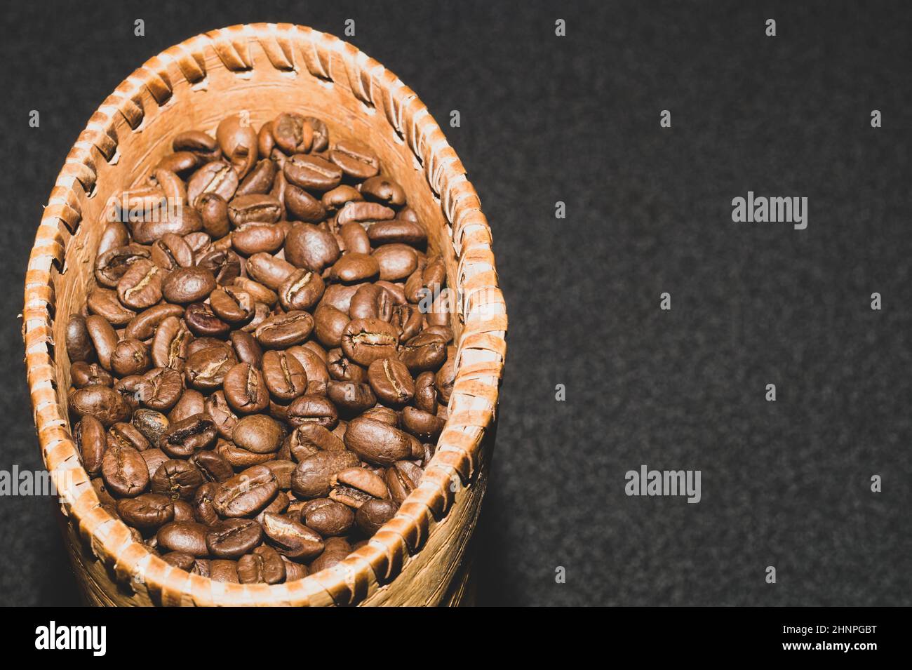 Coffee beans in a bark container. roasted coffee beans in a wooden jar Stock Photo - Alamy