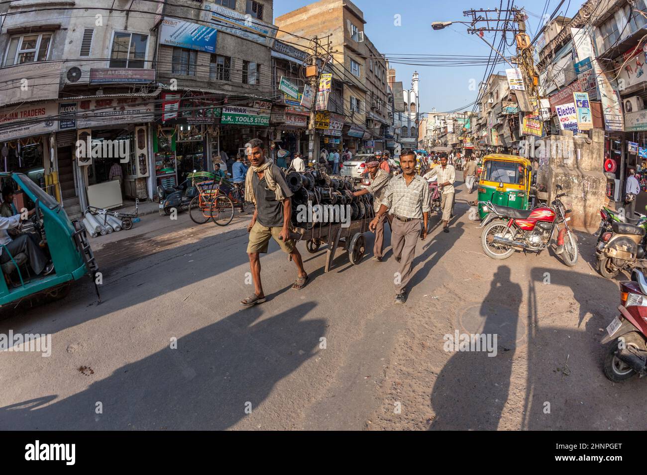 man carries heavy cargo with his wooden cart in old Delhi Stock Photo ...
