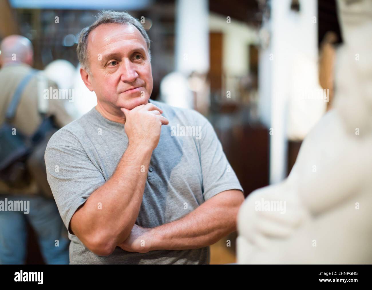 Man is looking at the art sculpture in historical museum Stock Photo ...