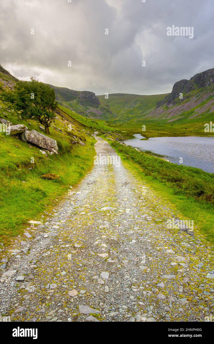 Beautiful valley on Dingle Peninsula with country road, lake and ...
