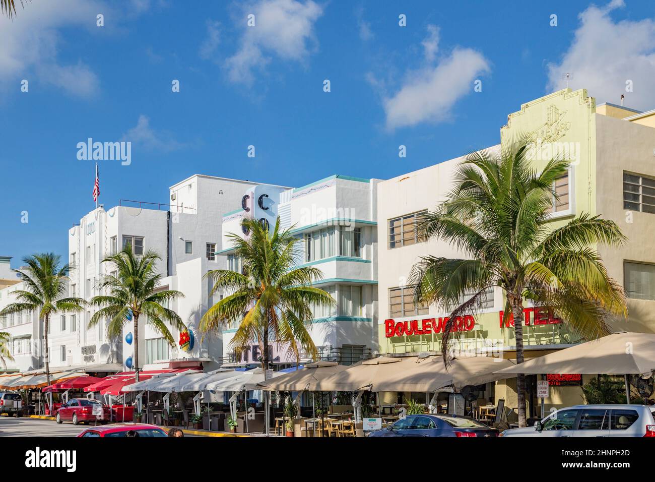 People walk along Ocean drive with Art Deco Hotels and Bars in South ...