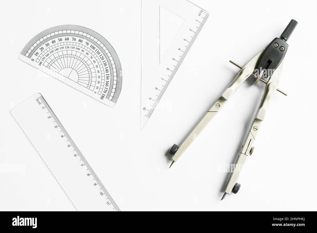 Compass and other measuring equipment on white paper Stock Photo - Alamy